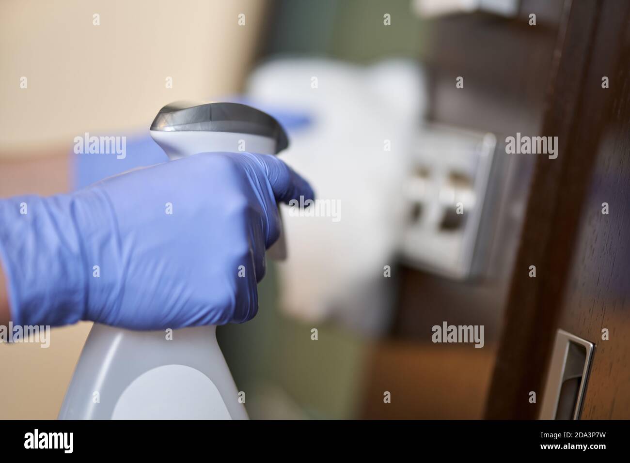 Close up of maid cleaning the hotel room with a disinfectant. Hotel ...