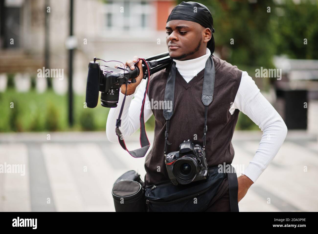 Young professional african american videographer holding professional ...