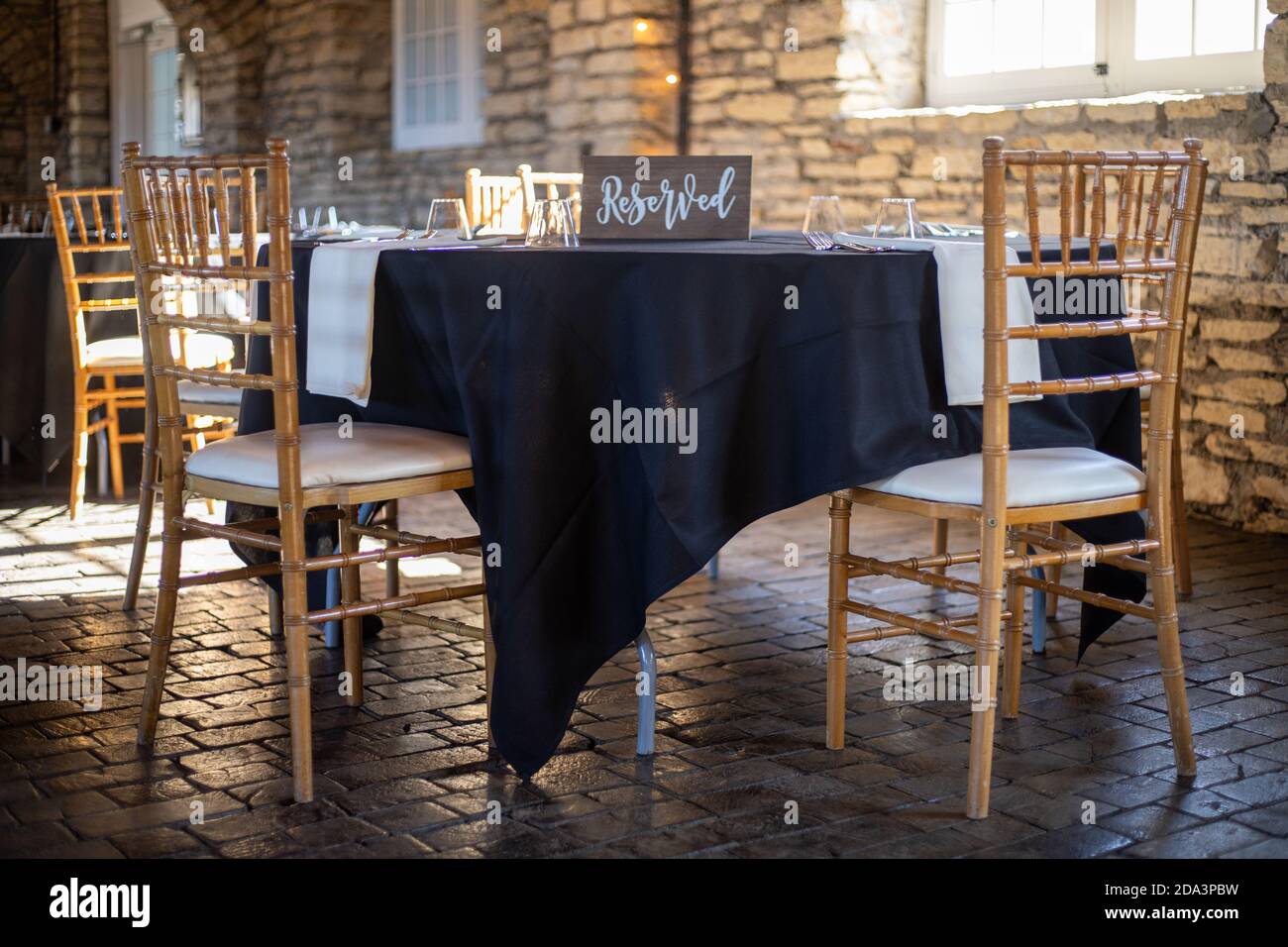 Reserved sign on the table in a restaurant under the sunlight through ...