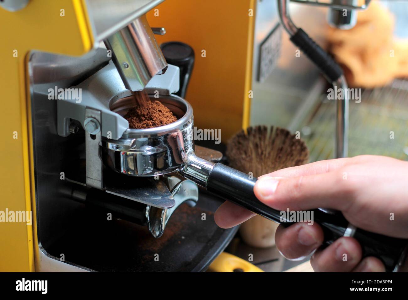 Barista hand holding an espresso coffee machine in a shop caffeine ...