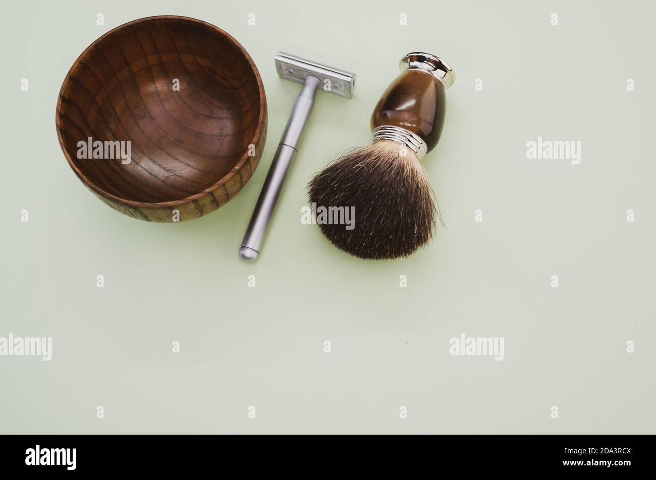 High angle shot of a wooden shaving water bowl near a shaving brush and ...