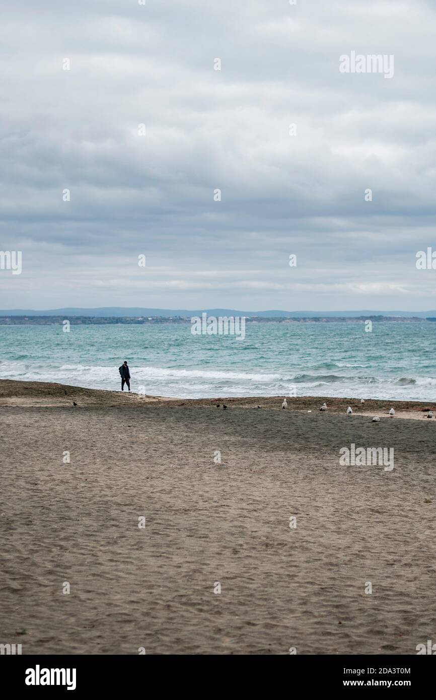 Lonely, sad woman walking on beach hi-res stock photography and images ...