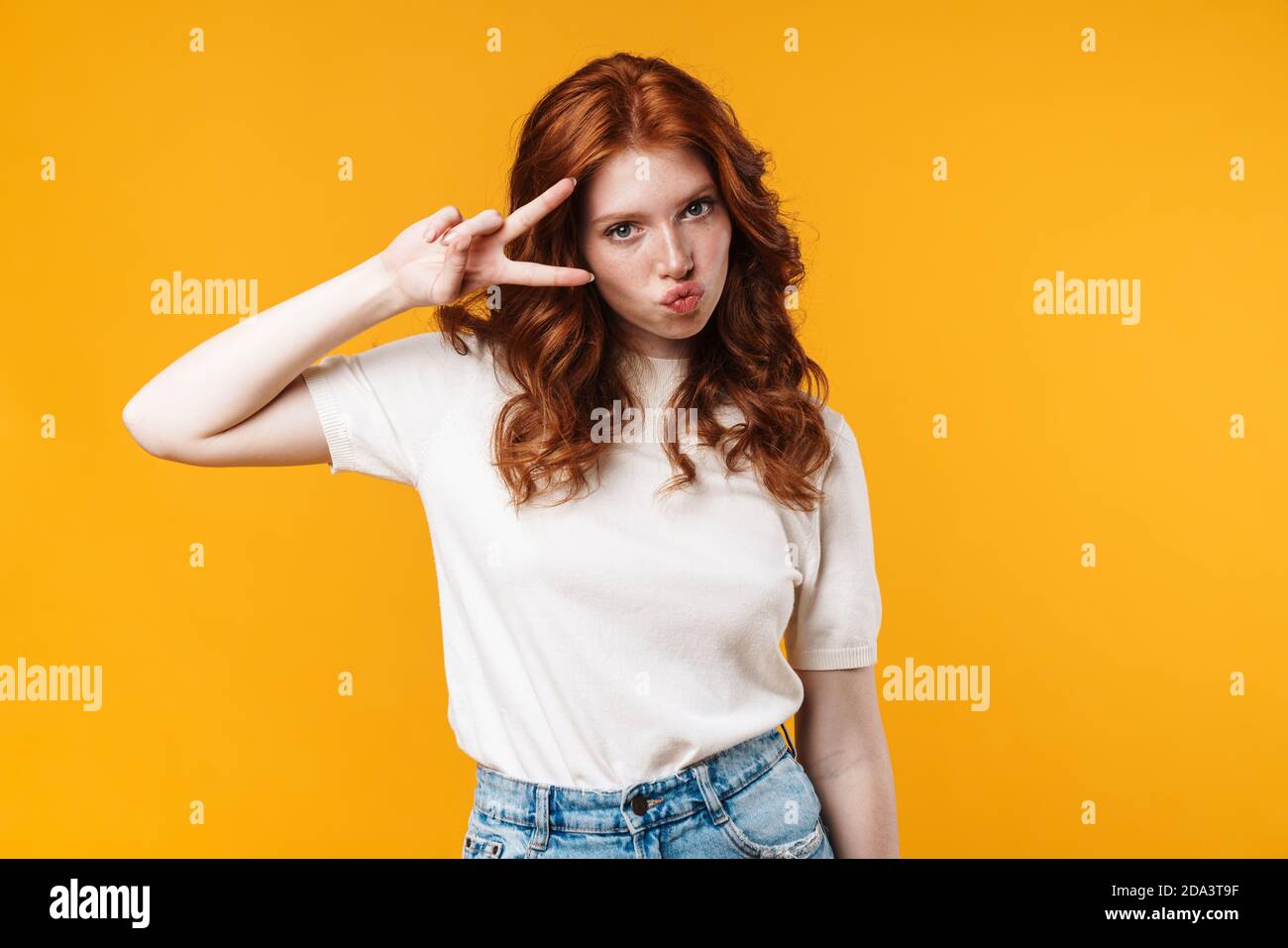Image of ginger nice girl making kiss lips and gesturing peace sign ...