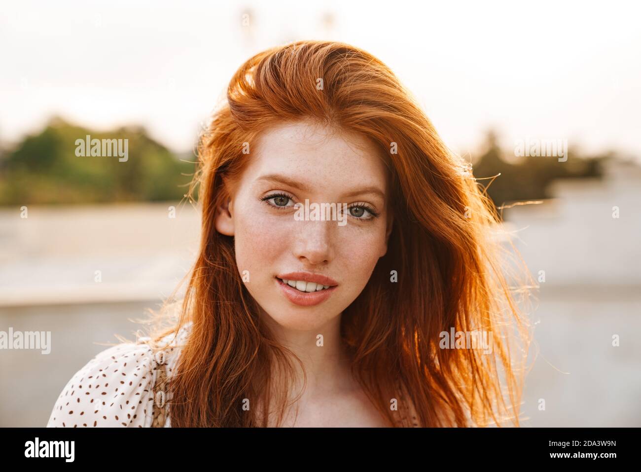 Image of young ginger girl smiling while smiling and looking at camera ...