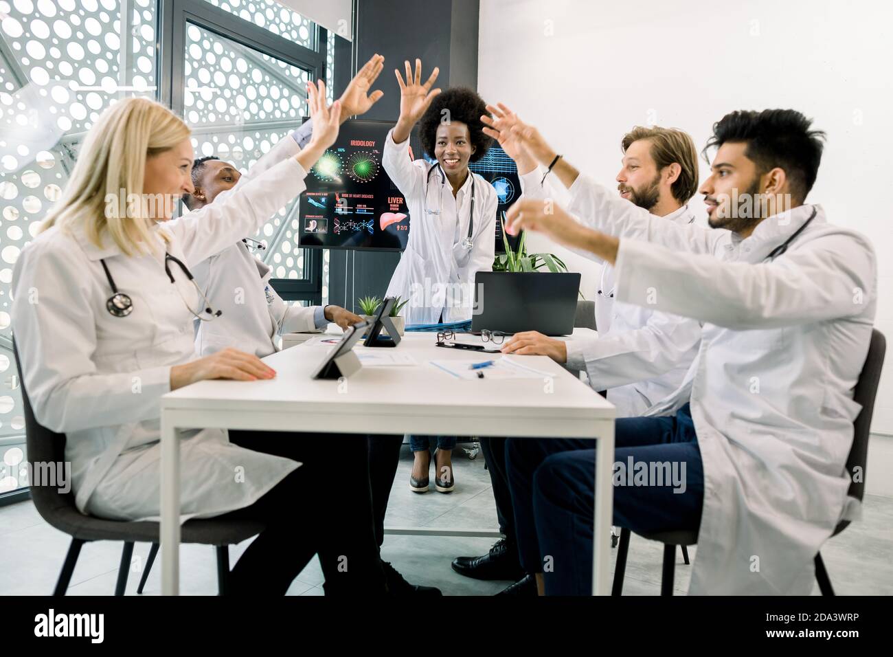 Group of motivated international doctors or scientists, sitting around ...