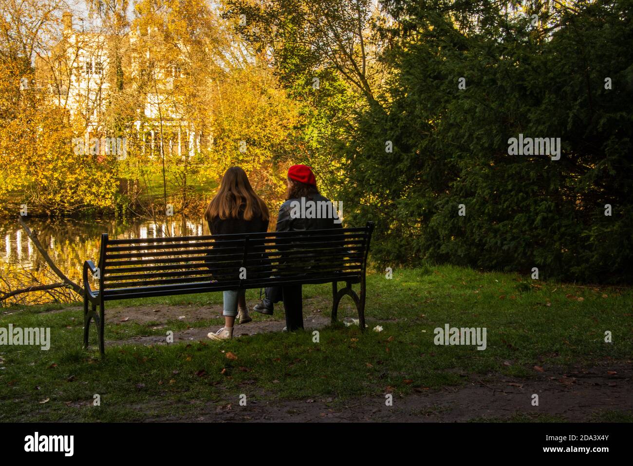 Two girls sitting in the park hi-res stock photography and images - Alamy
