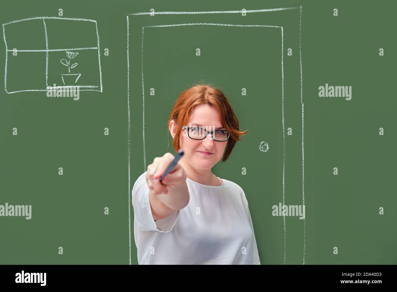 School teacher is pointing at you. Door drawn in chalk on a blackboard ...