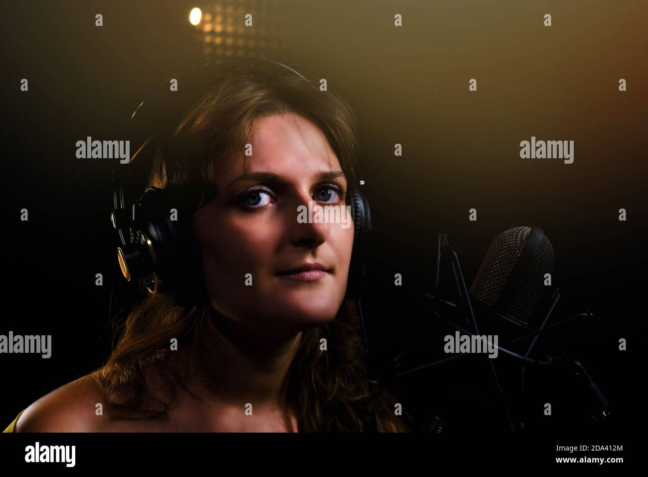 Woman singer looking at the camera at the recording Studio, black ...