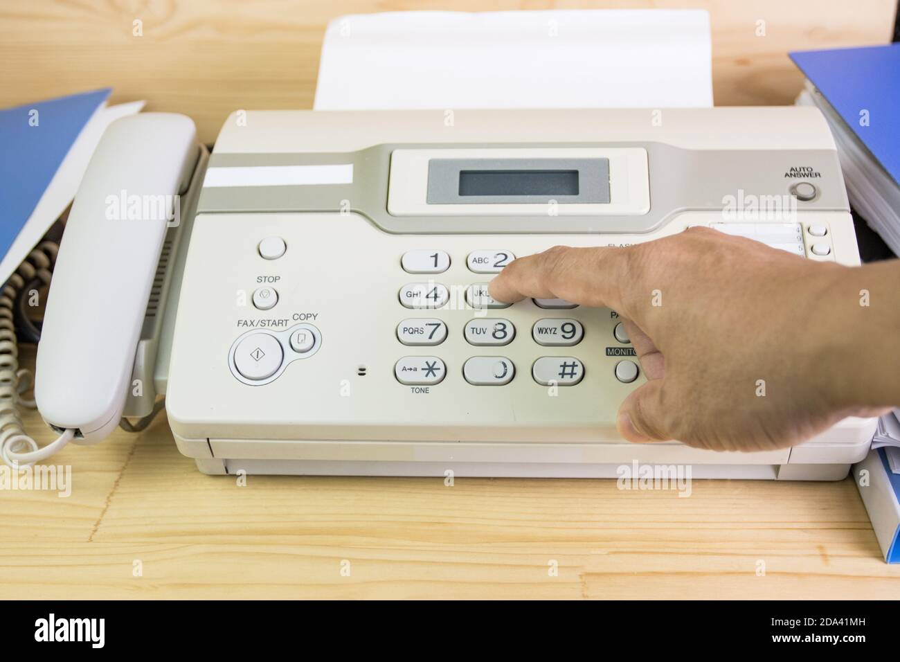 hand man are using a fax machine in the office, equipment for data ...