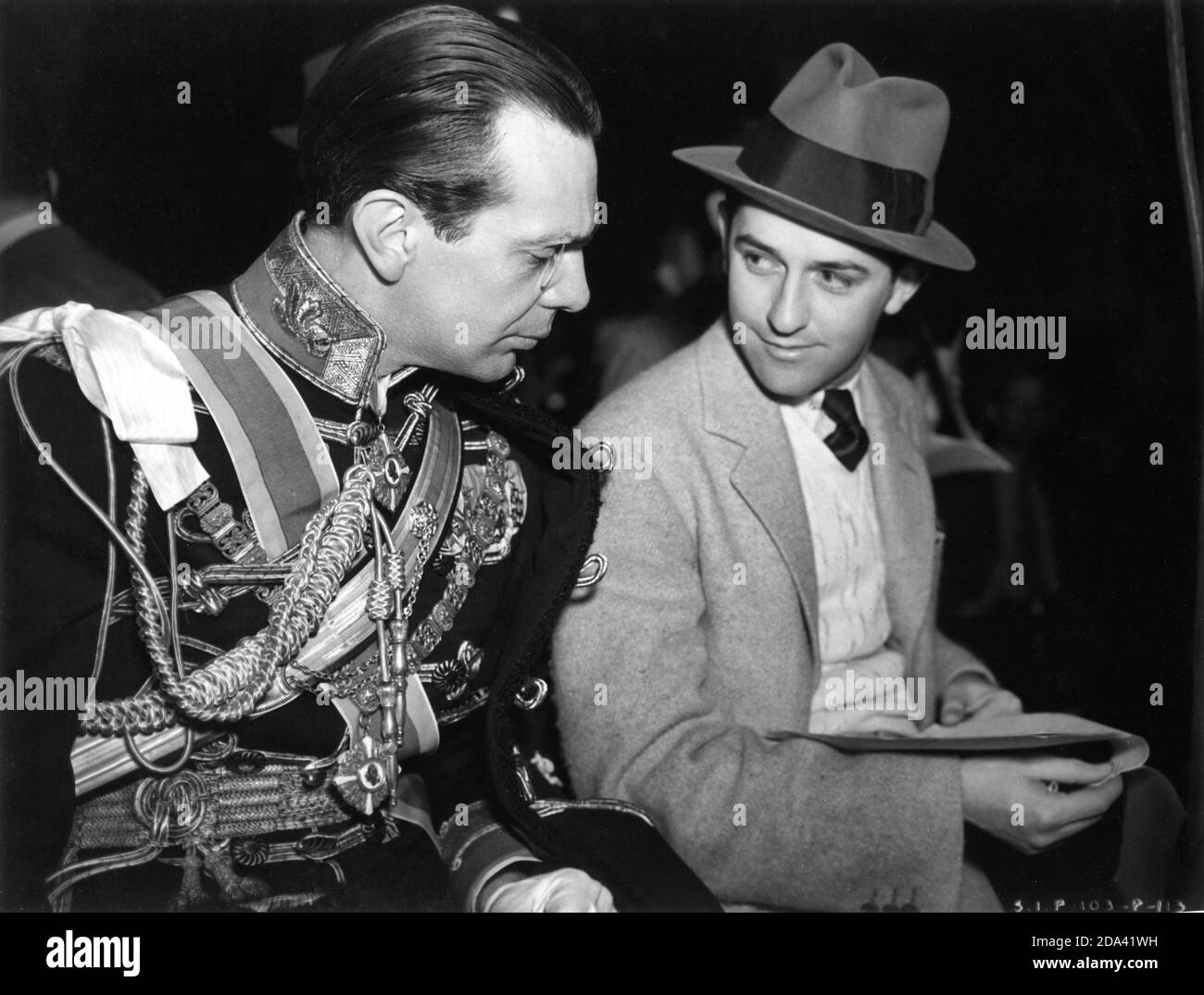 RAYMOND MASSEY and Assistant to the Producer WILLIAM H. WRIGHT on set candid during filming of ...