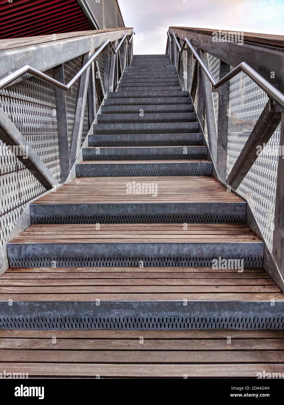 Stairs with stainless steel hand railings and wooden steps. Staircase ...