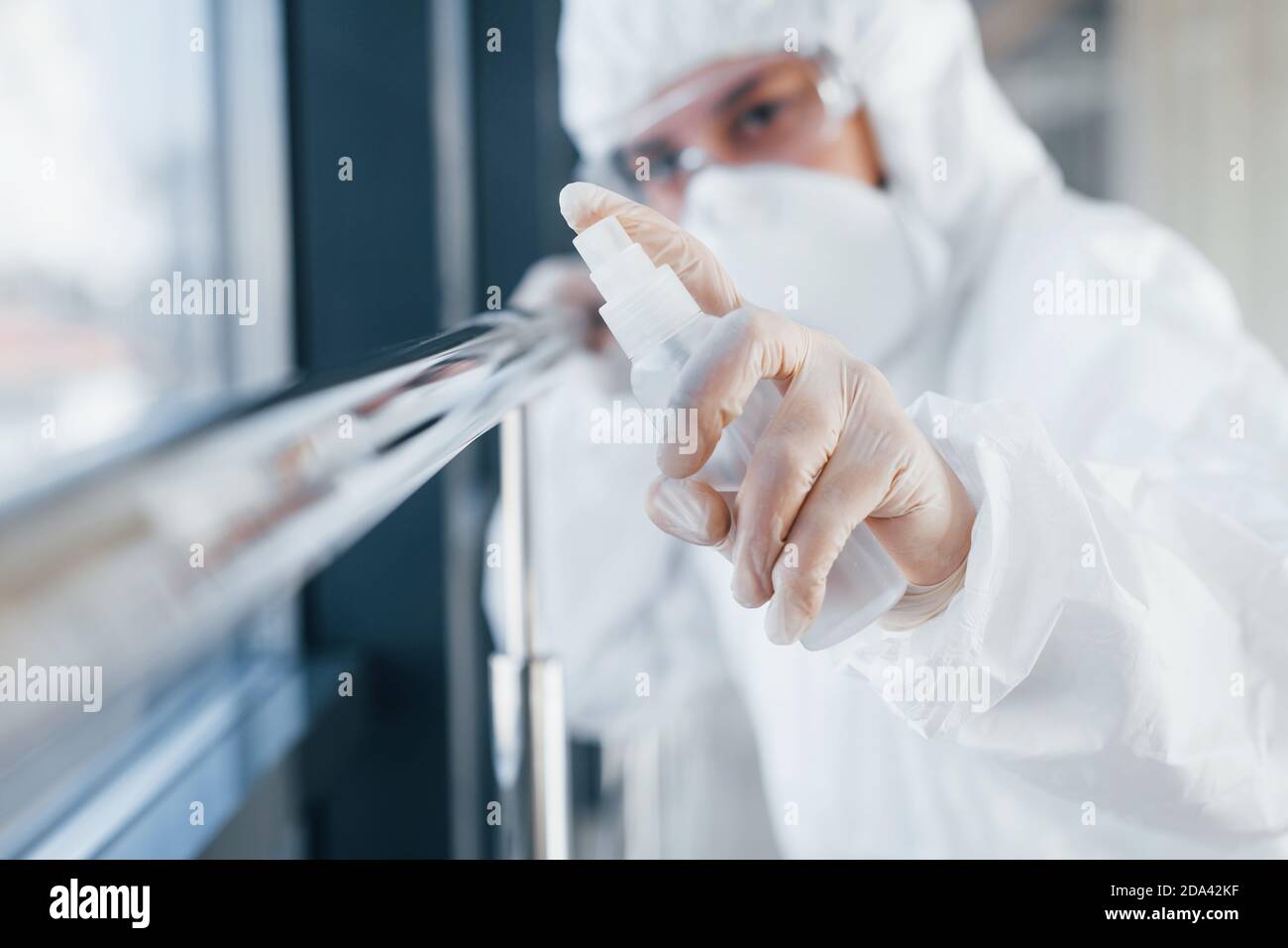 Female doctor scientist in lab coat, defensive eyewear and mask ...
