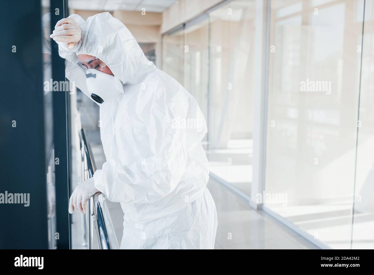 Feels bad and sick. Female doctor scientist in lab coat, defensive ...