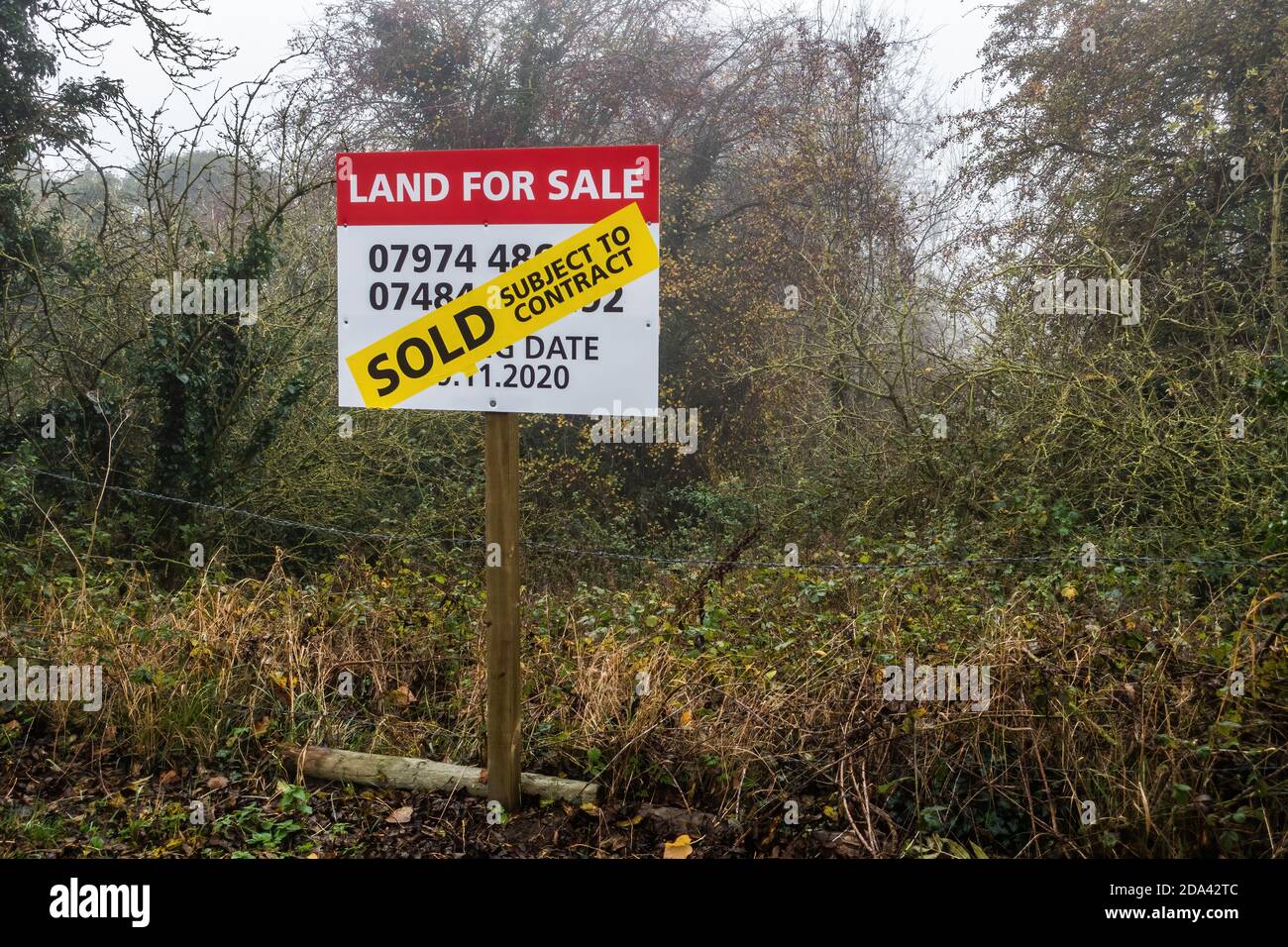 Land for sale sign with sold banner on it Stock Photo - Alamy