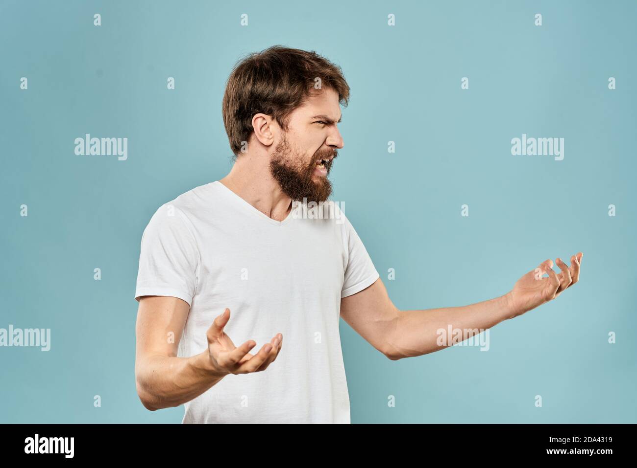 Man gestures with his hands emotions displeasure white t-shirt blue ...