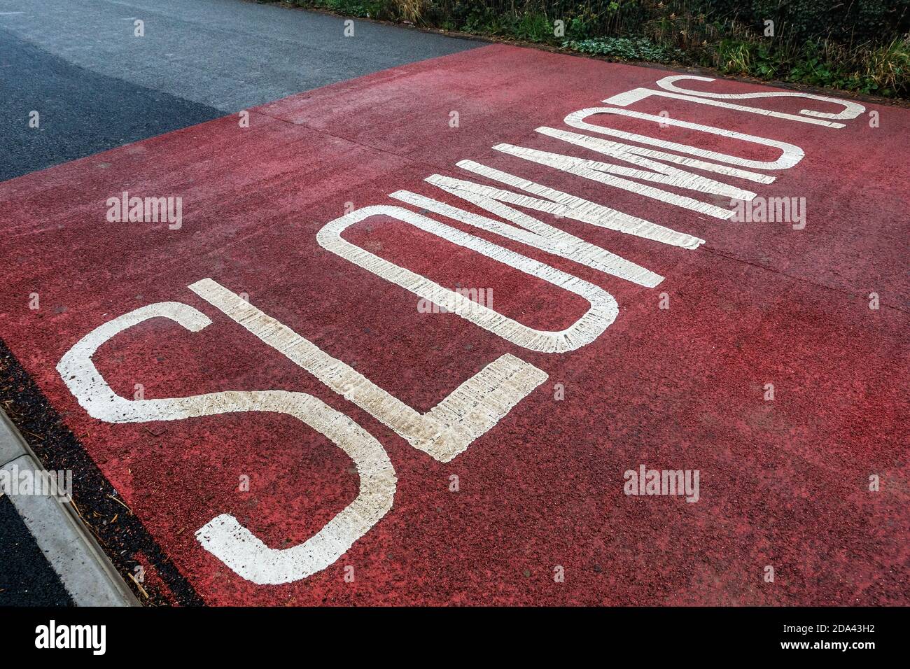 Slow sign written on the road tarmac Stock Photo - Alamy