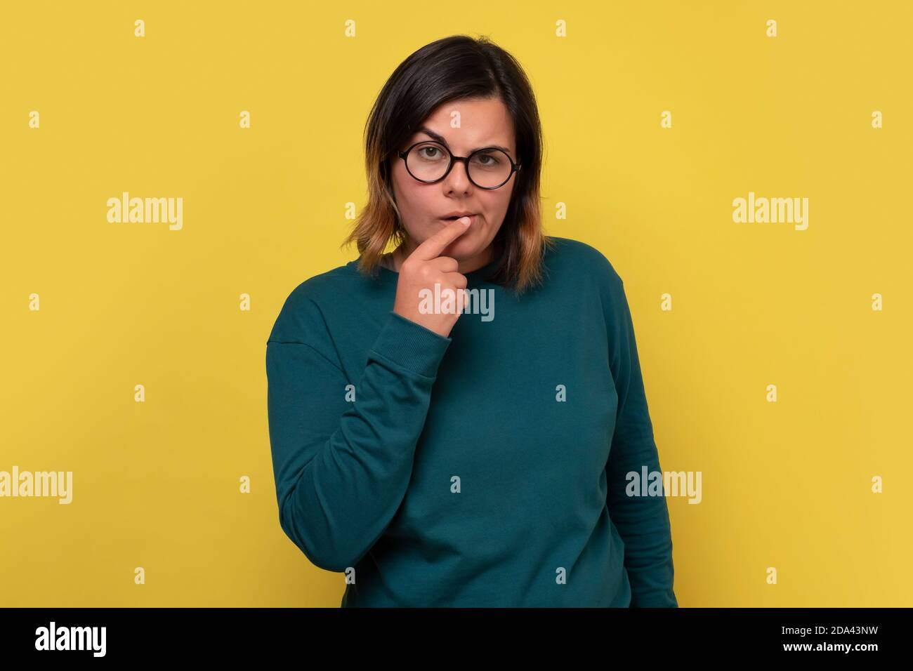Caucasian woman with glasses having thoughtful look Stock Photo - Alamy