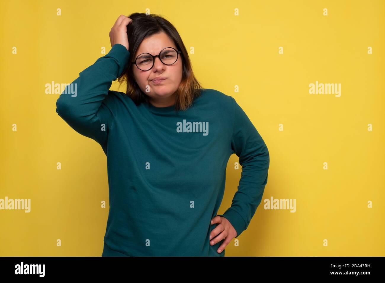 Caucasian woman with glasses having thoughtful look Stock Photo - Alamy