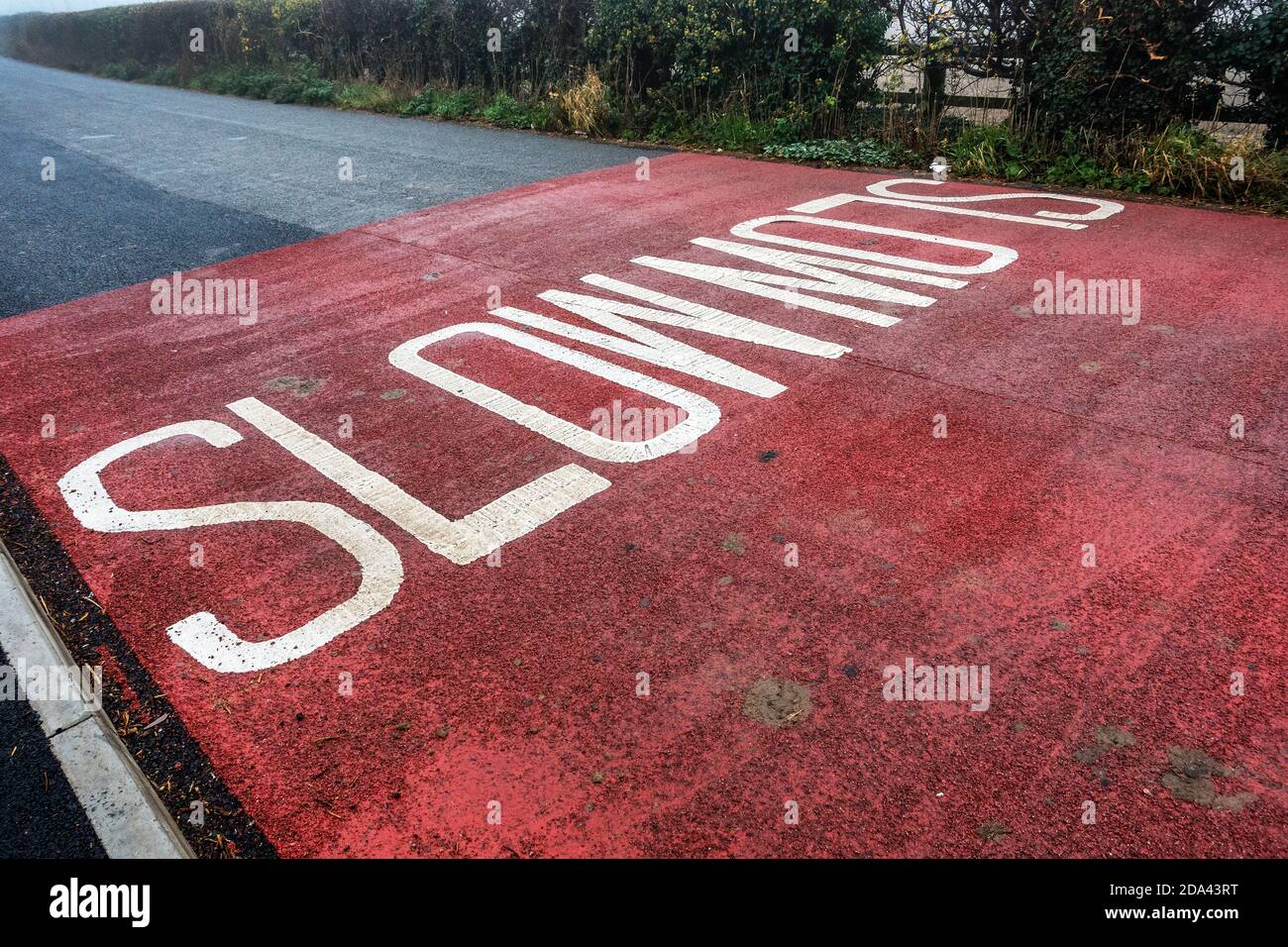 slow sign written on the road Stock Photo - Alamy