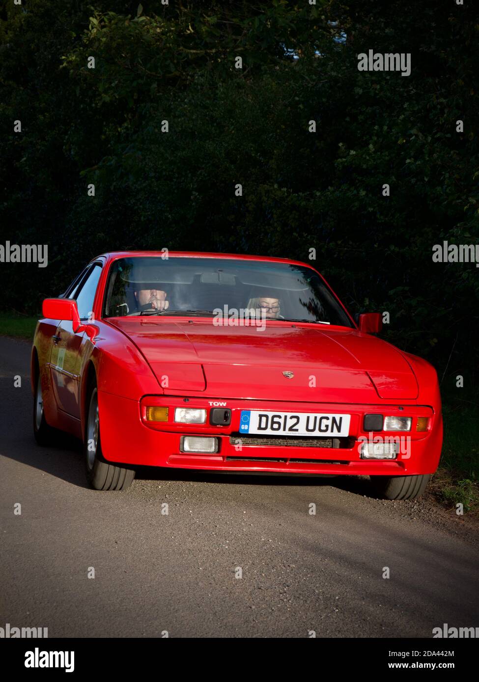 Rally driving into the evening sun in a red Porsche 944 Stock Photo - Alamy