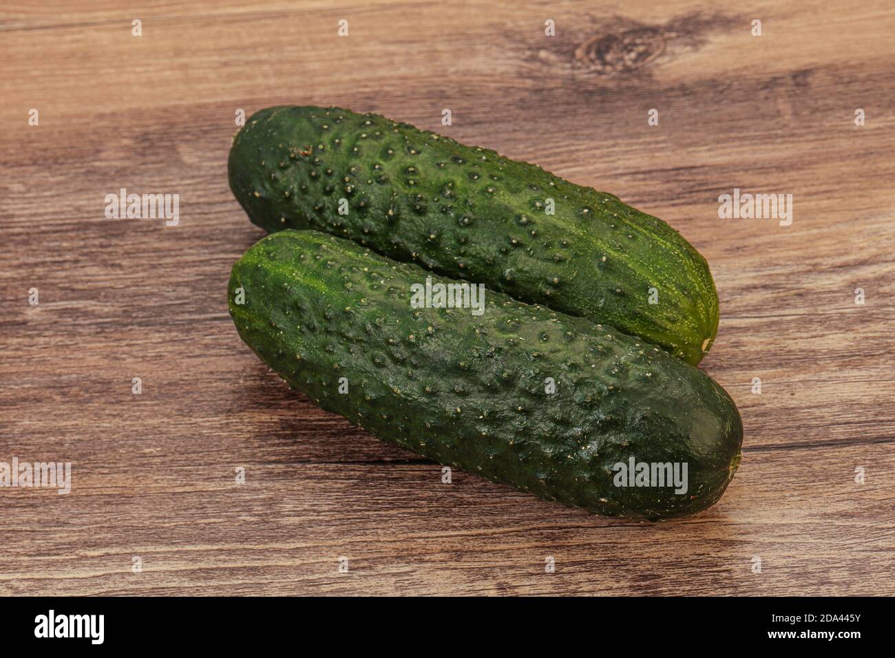 Green fresh two cucumbers over background Stock Photo - Alamy