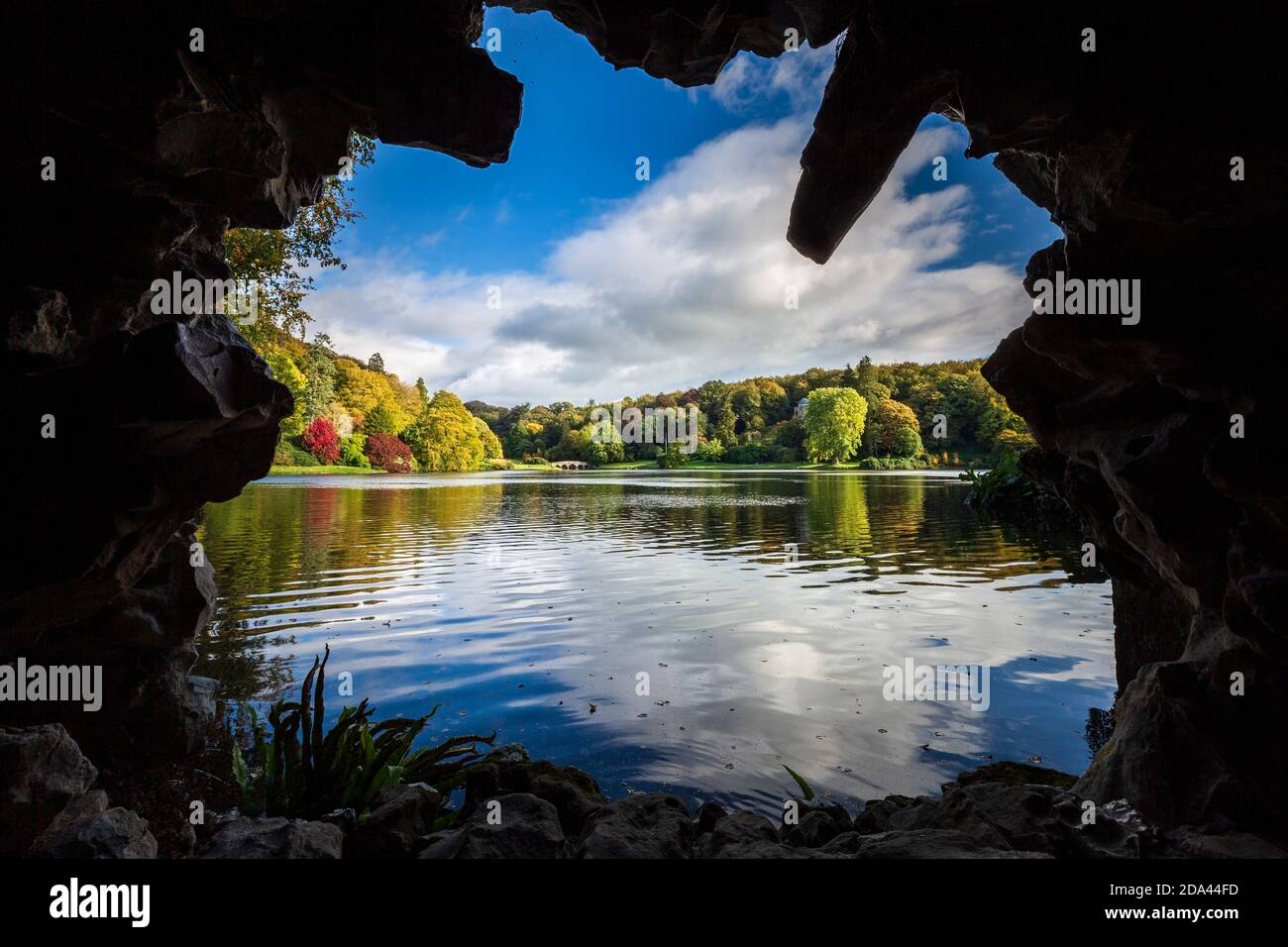 Autumn colour across the lake from the Grotto at Stourhead in Wiltshire ...
