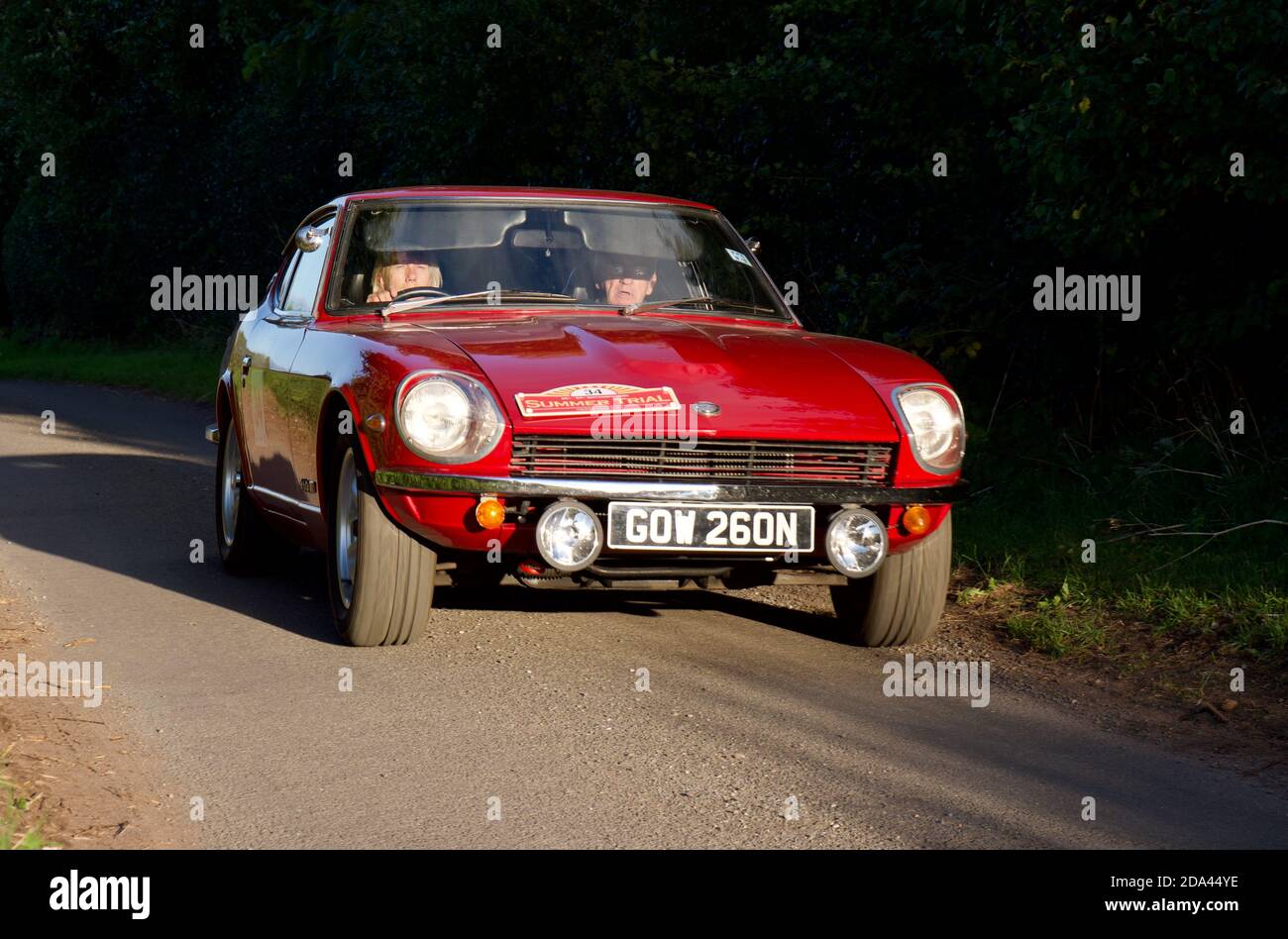 Blinded by the sun driving a red Datsun 260Z Stock Photo - Alamy
