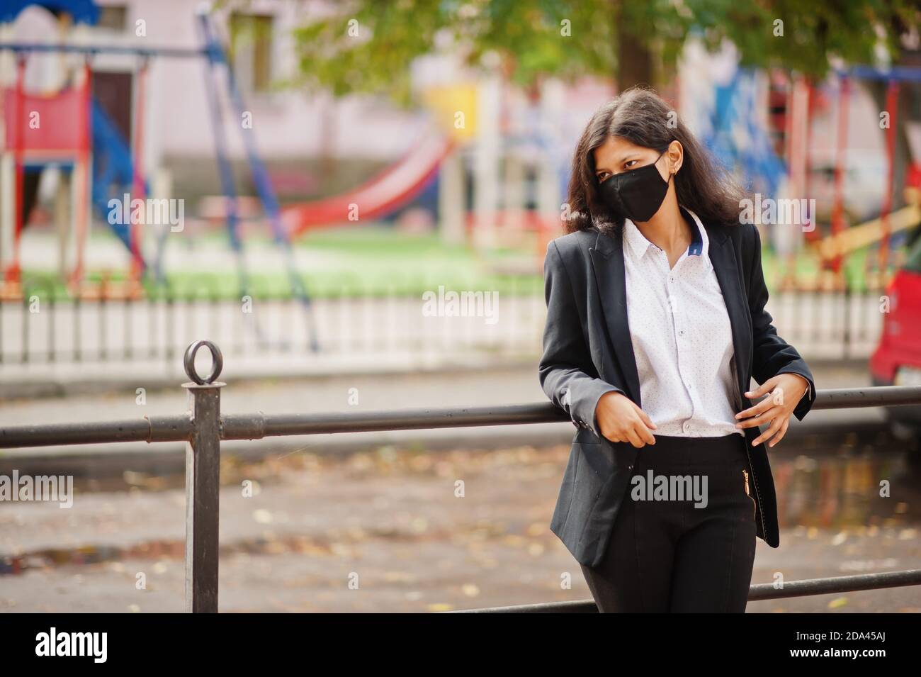 Gorgeous indian woman wear formal and black face mask, posing at street ...
