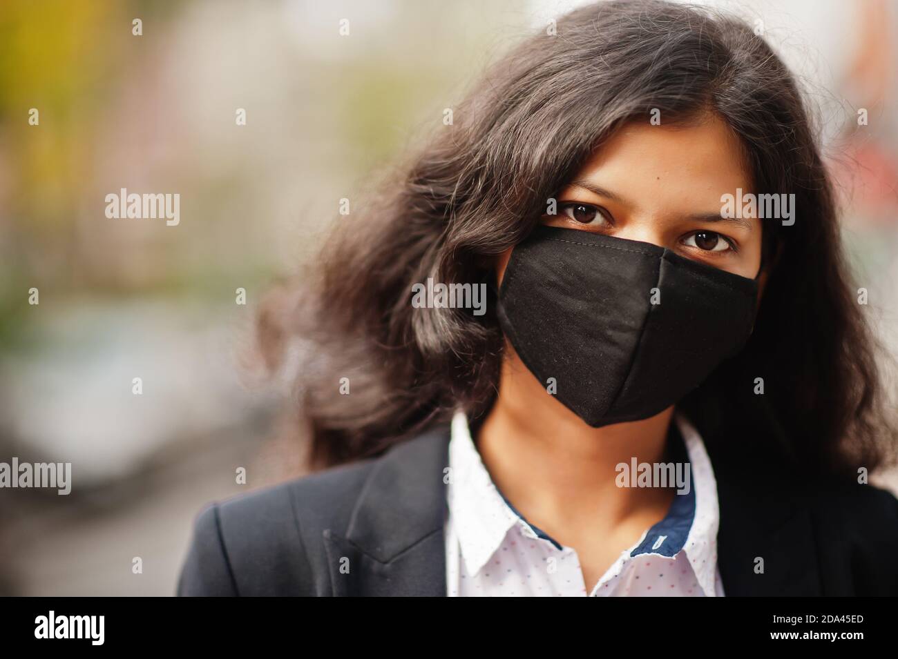 Gorgeous indian woman wear formal and black face mask, posing at street ...