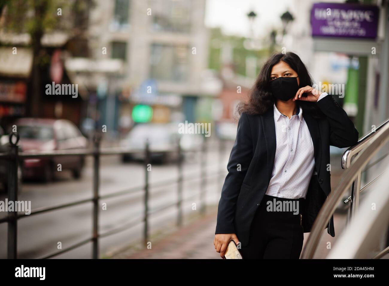 Gorgeous indian woman wear formal and black face mask, posing at street ...