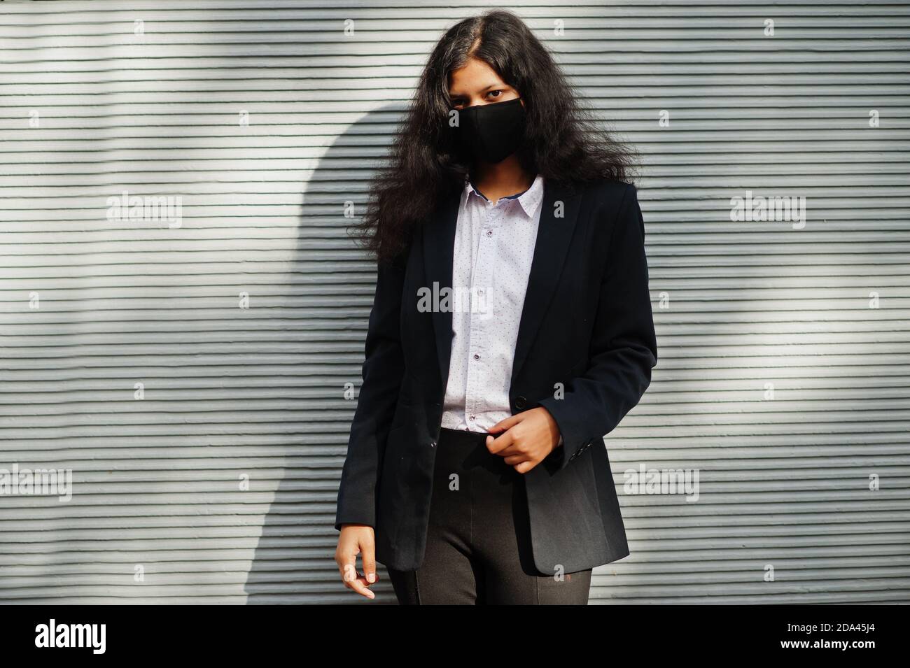 Gorgeous indian woman wear formal and black face mask, posing against ...