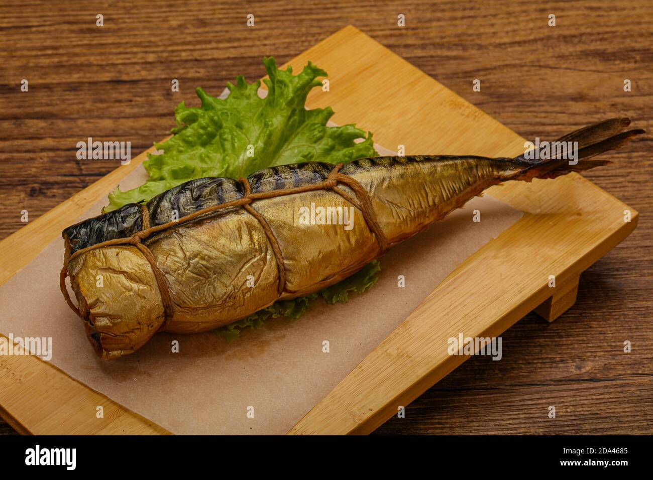 Smoked tasty mackerel fish snack over board Stock Photo - Alamy