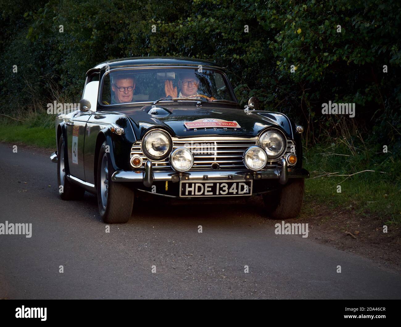 Triumph TR4 A being driven in an evening rally Stock Photo - Alamy