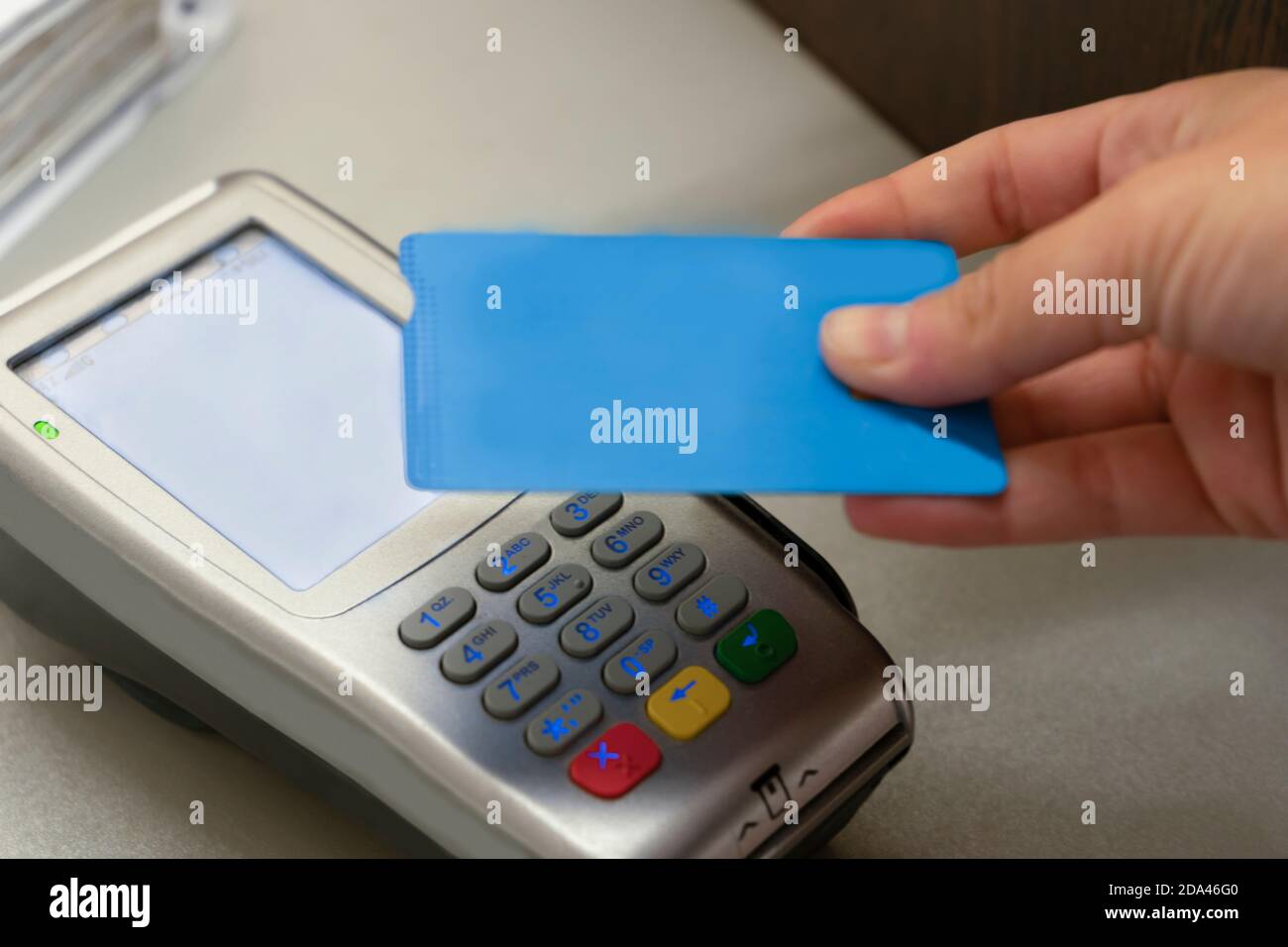 Customer paying by credit card, closeup view of woman hand. Contact and ...