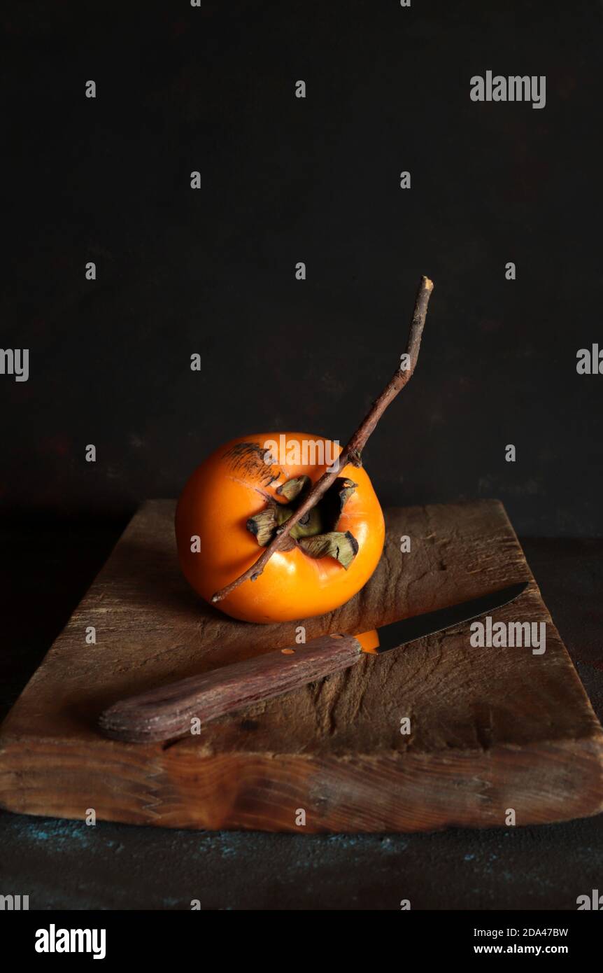 Persimmon isolated on dark background Stock Photo - Alamy
