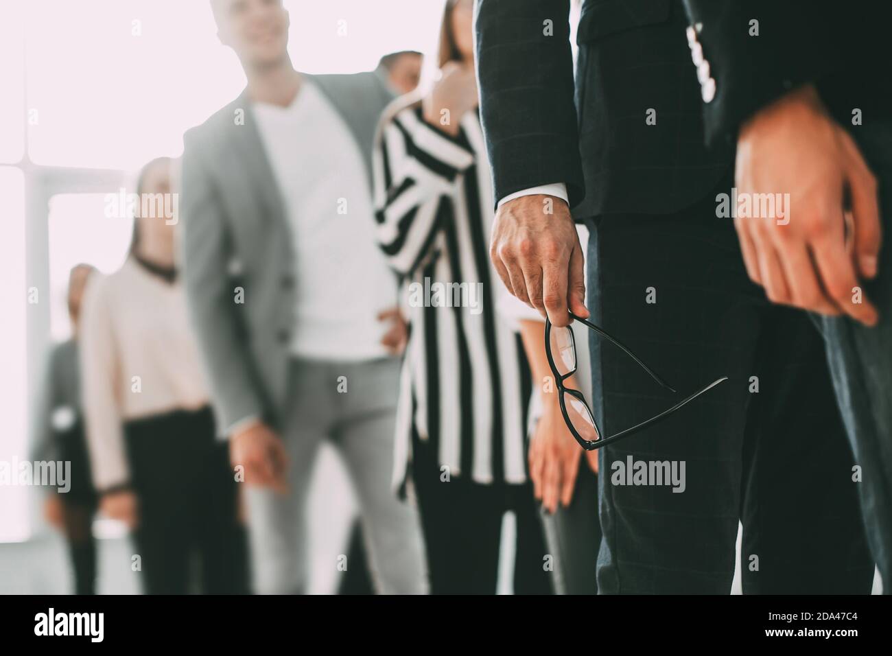 close up. young business man standing in a long queue Stock Photo - Alamy
