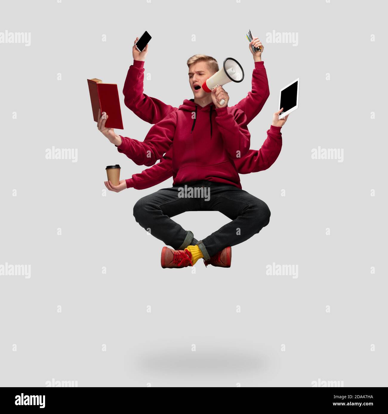 Handsome student, multi-armed man levitating isolated on grey studio ...