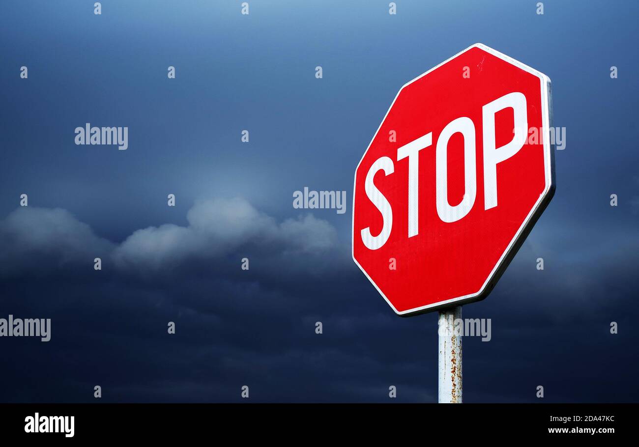 Conceptual stop sign with stormy background. Warning, caution and ...