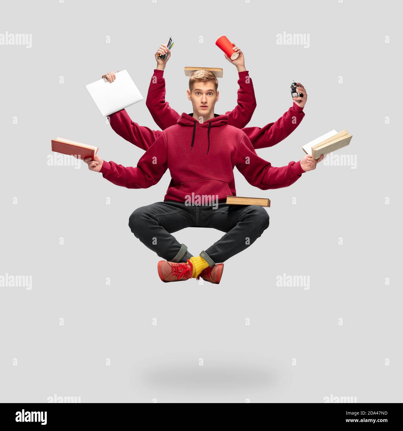 Handsome student, multi-armed man levitating isolated on grey studio ...