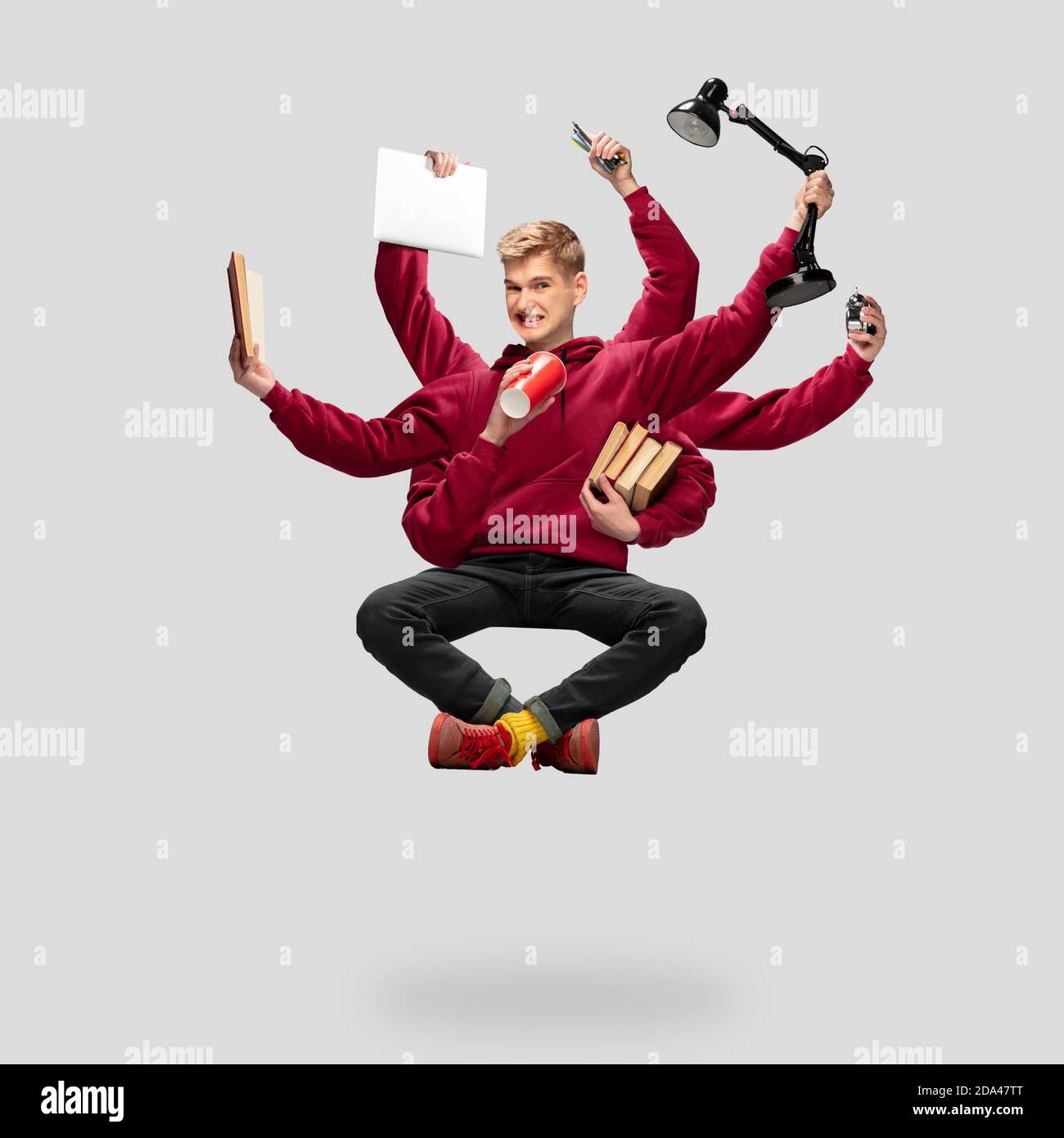 Handsome student, multi-armed man levitating isolated on grey studio ...