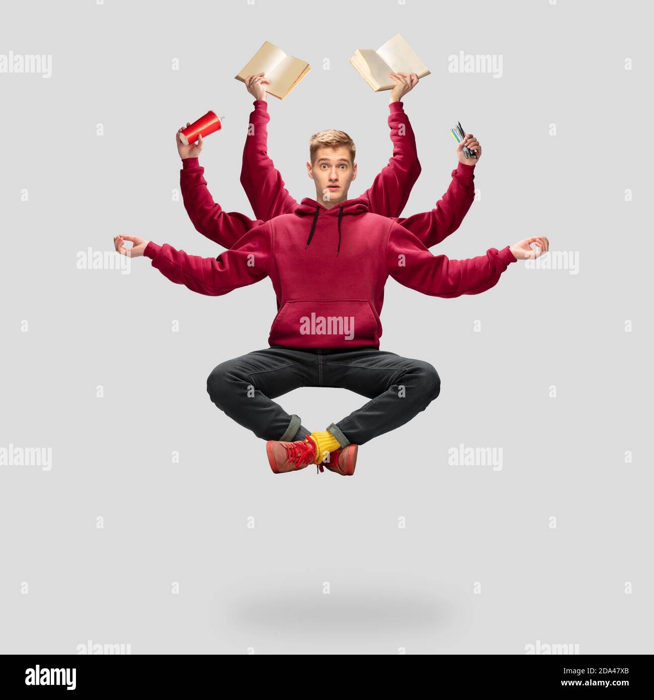 Handsome student, multi-armed man levitating isolated on grey studio ...