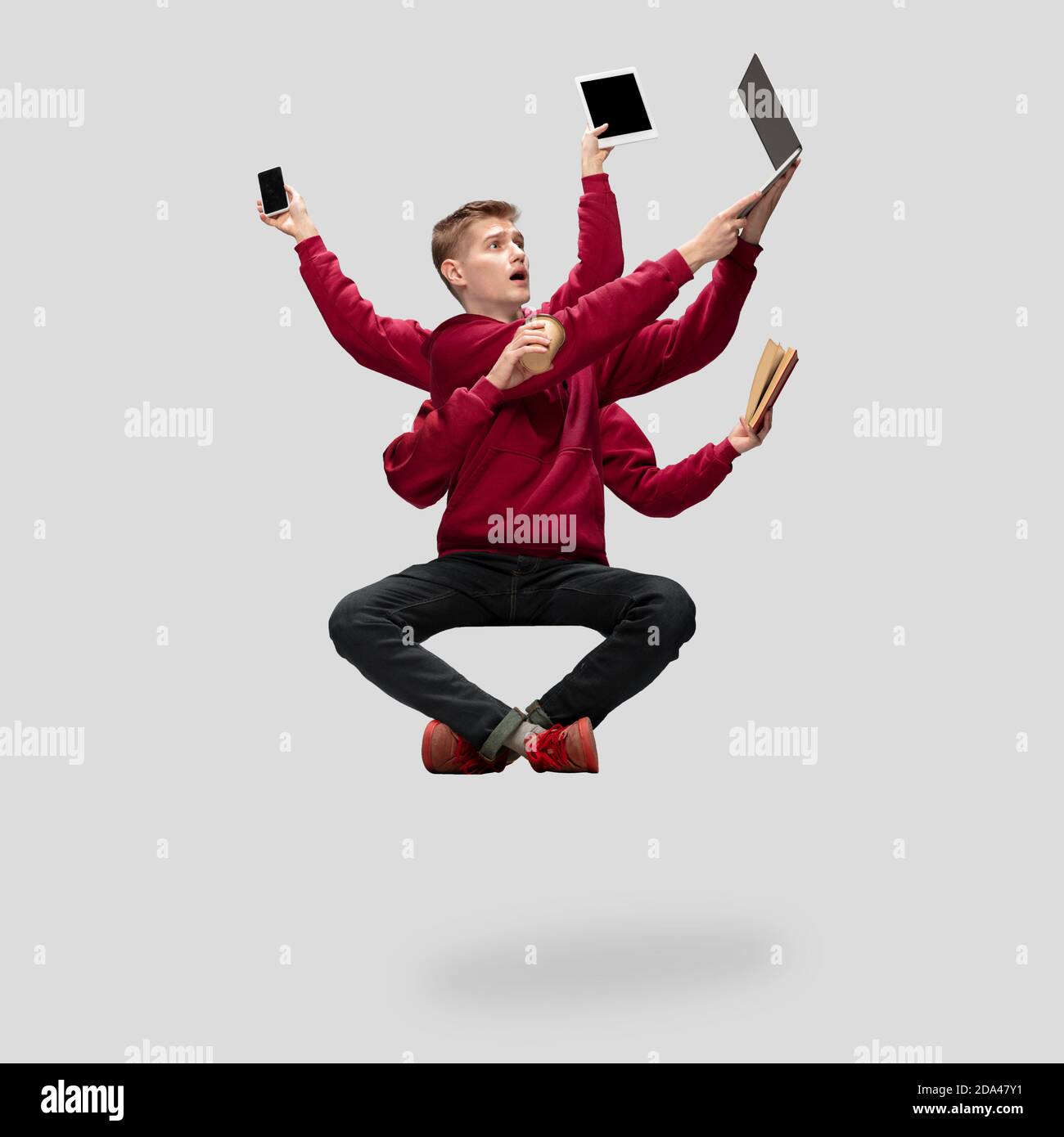 Handsome student, multi-armed man levitating isolated on grey studio ...