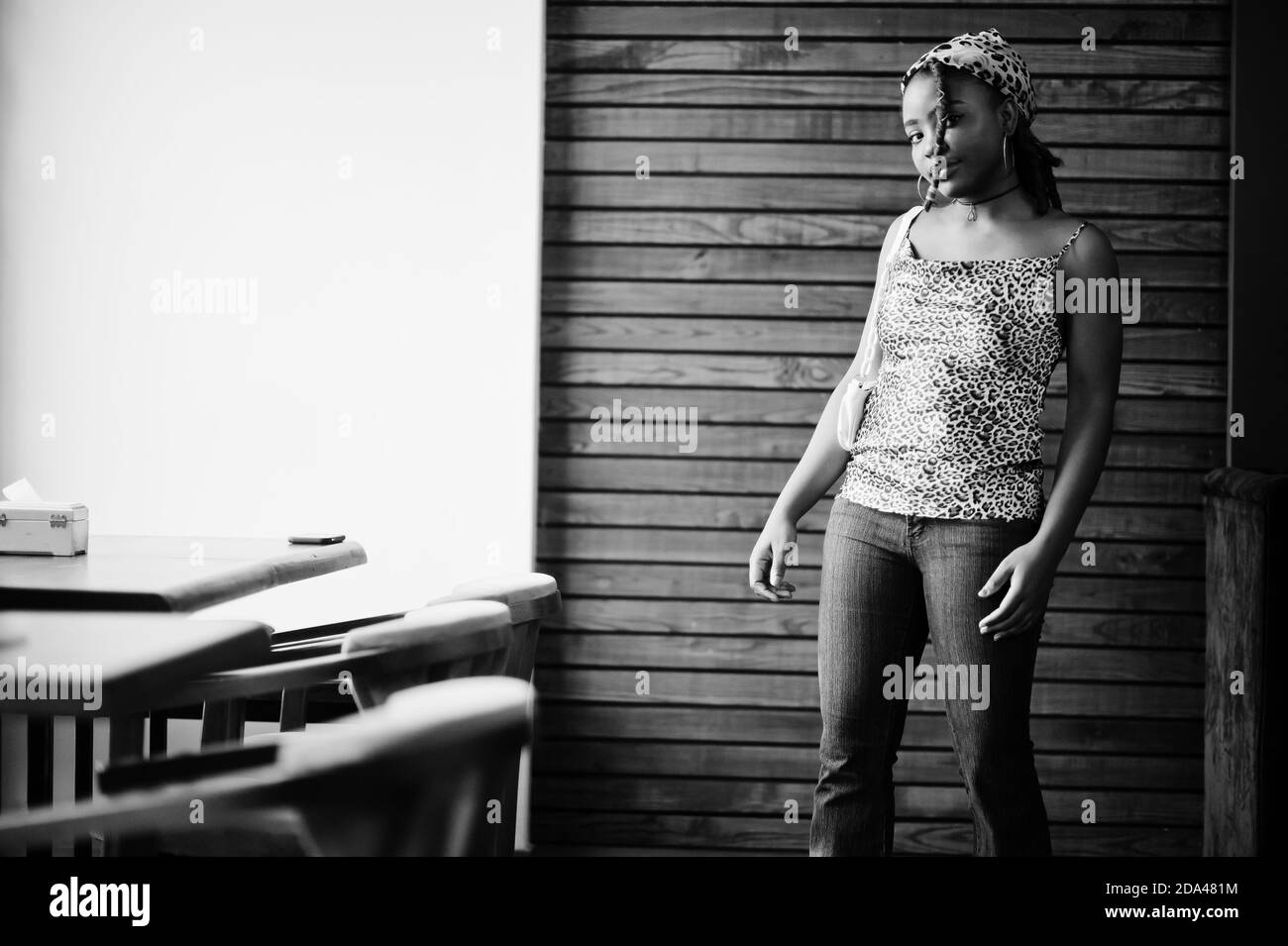 Lovely african american woman with dreadlocks in leopard outfit at cafe ...