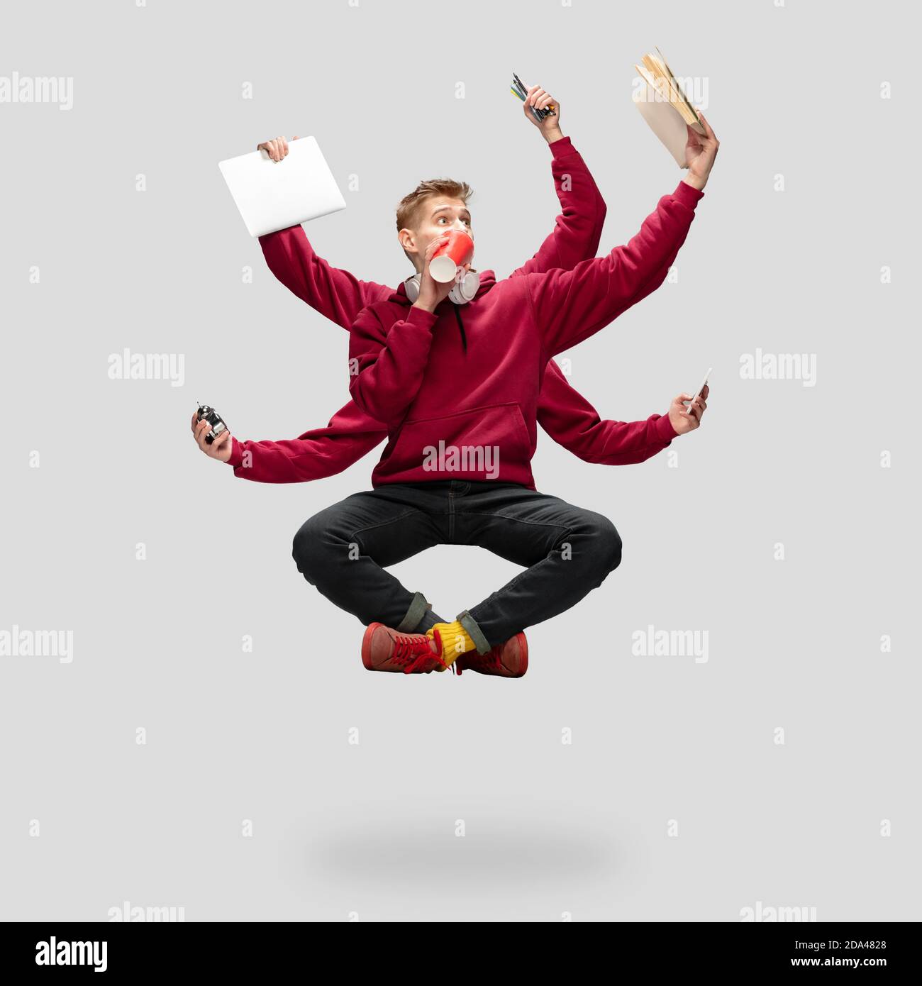Handsome student, multi-armed man levitating isolated on grey studio ...