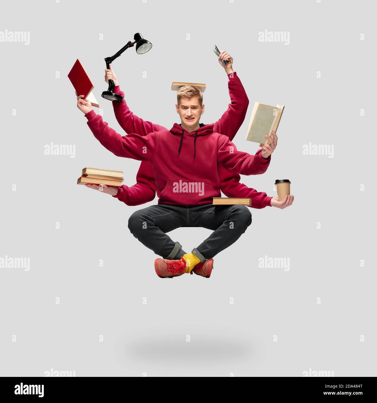 Handsome student, multi-armed man levitating isolated on grey studio ...