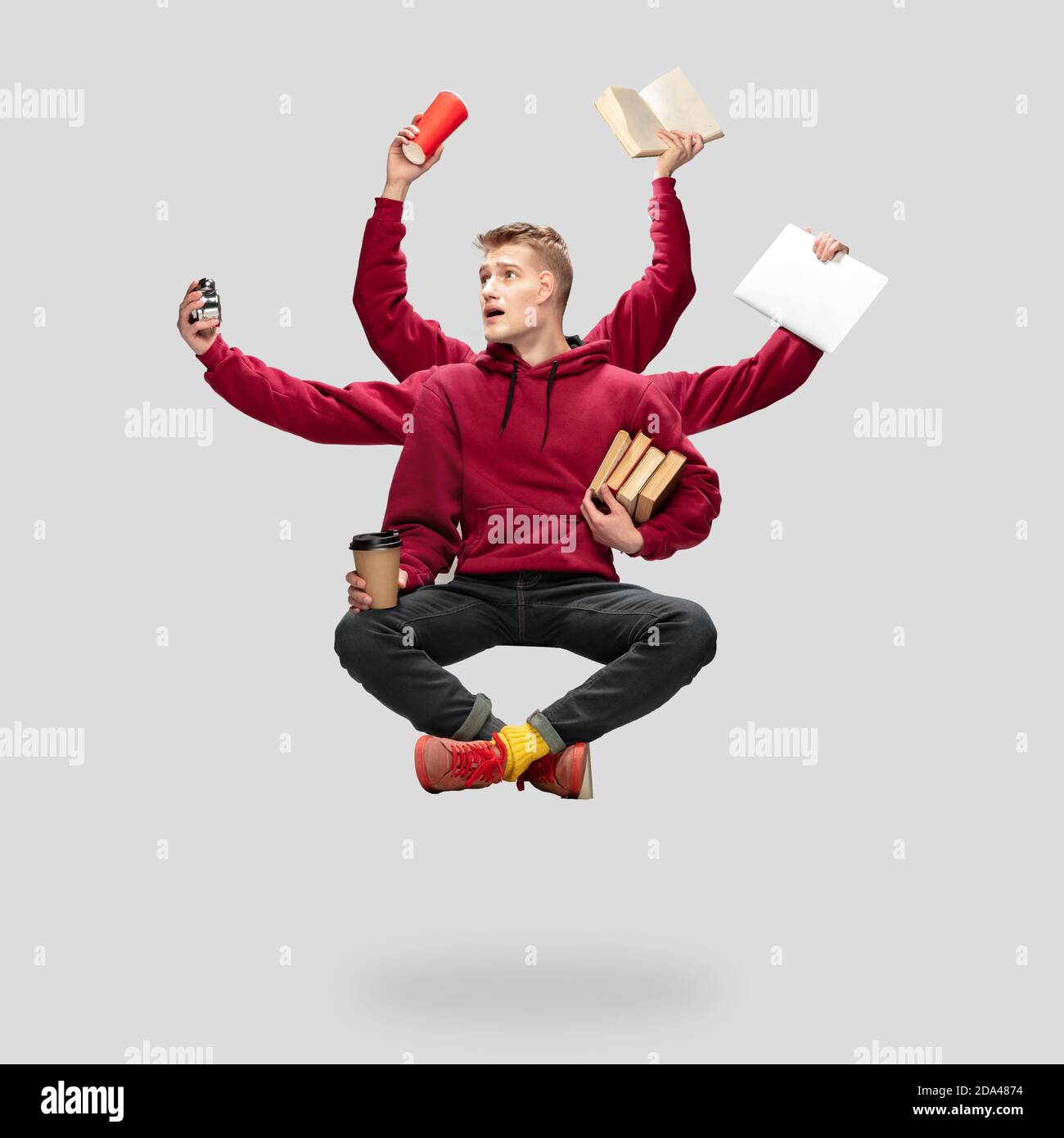 Handsome student, multi-armed man levitating isolated on grey studio ...