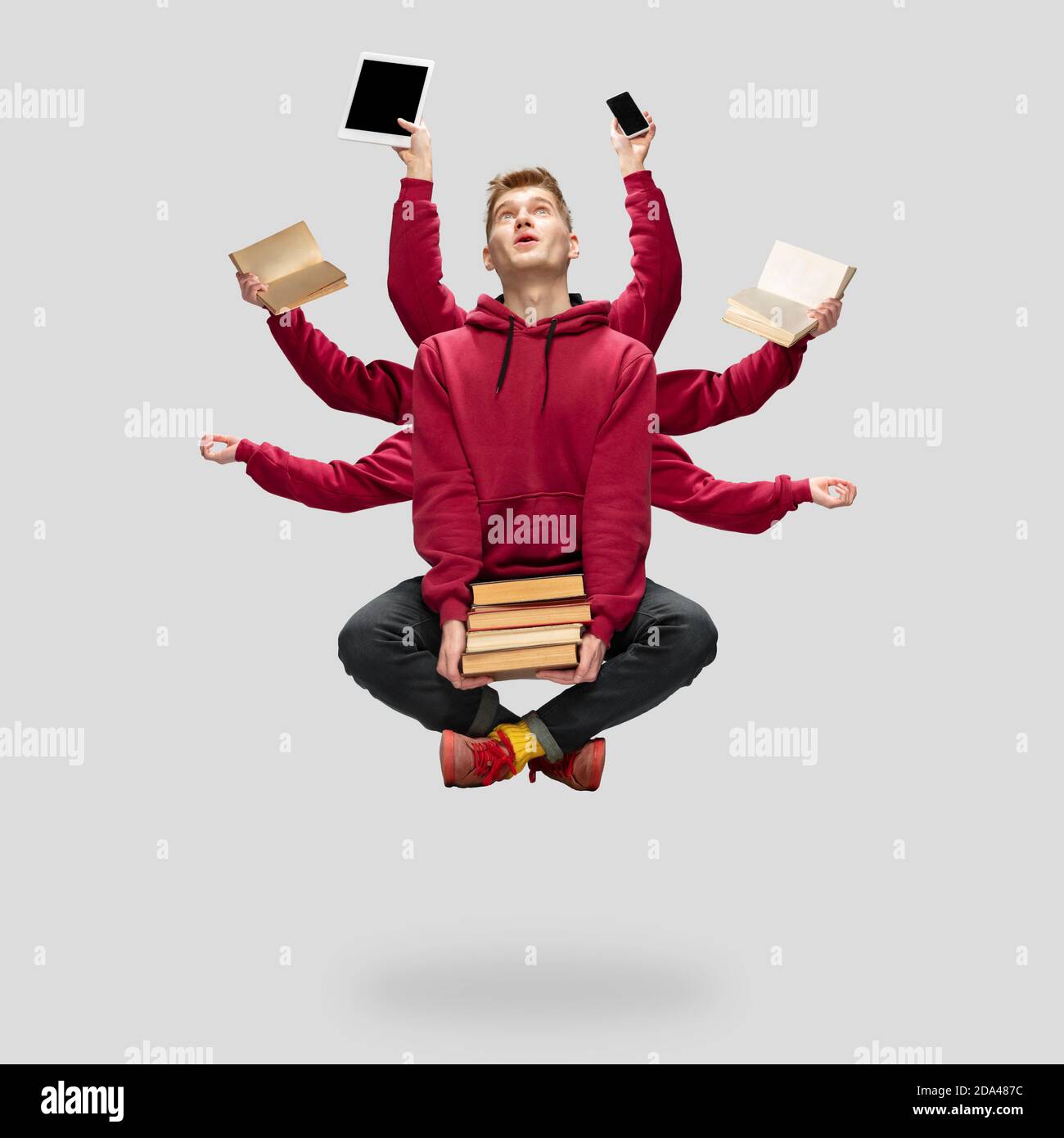 Handsome student, multi-armed man levitating isolated on grey studio ...