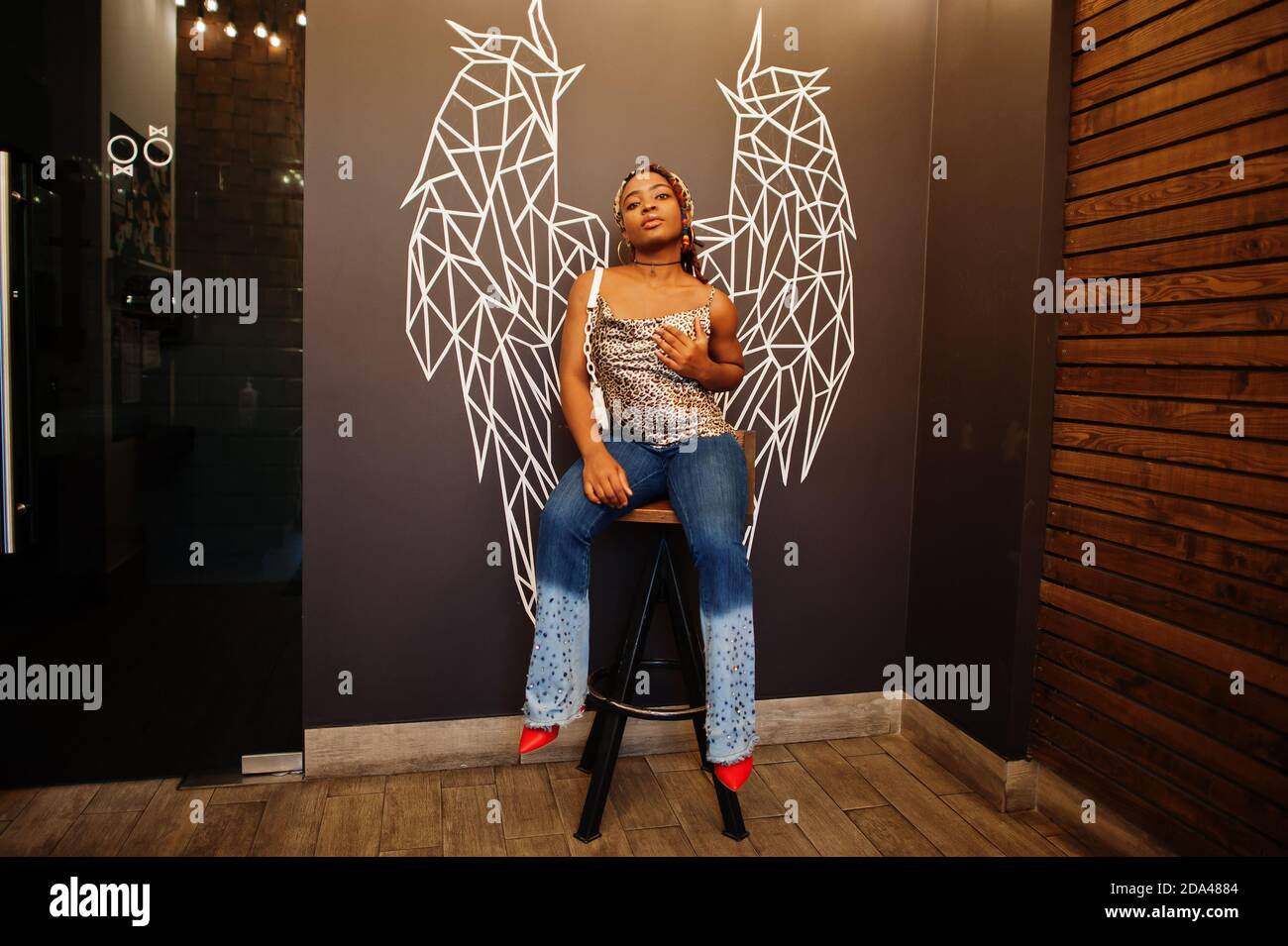 Lovely african american woman with dreadlocks in leopard outfit against ...
