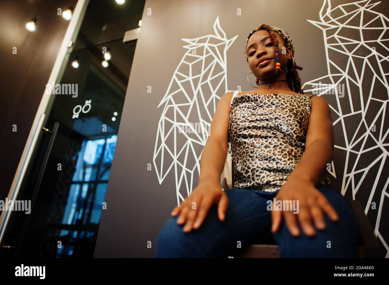 Lovely african american woman with dreadlocks in leopard outfit against ...