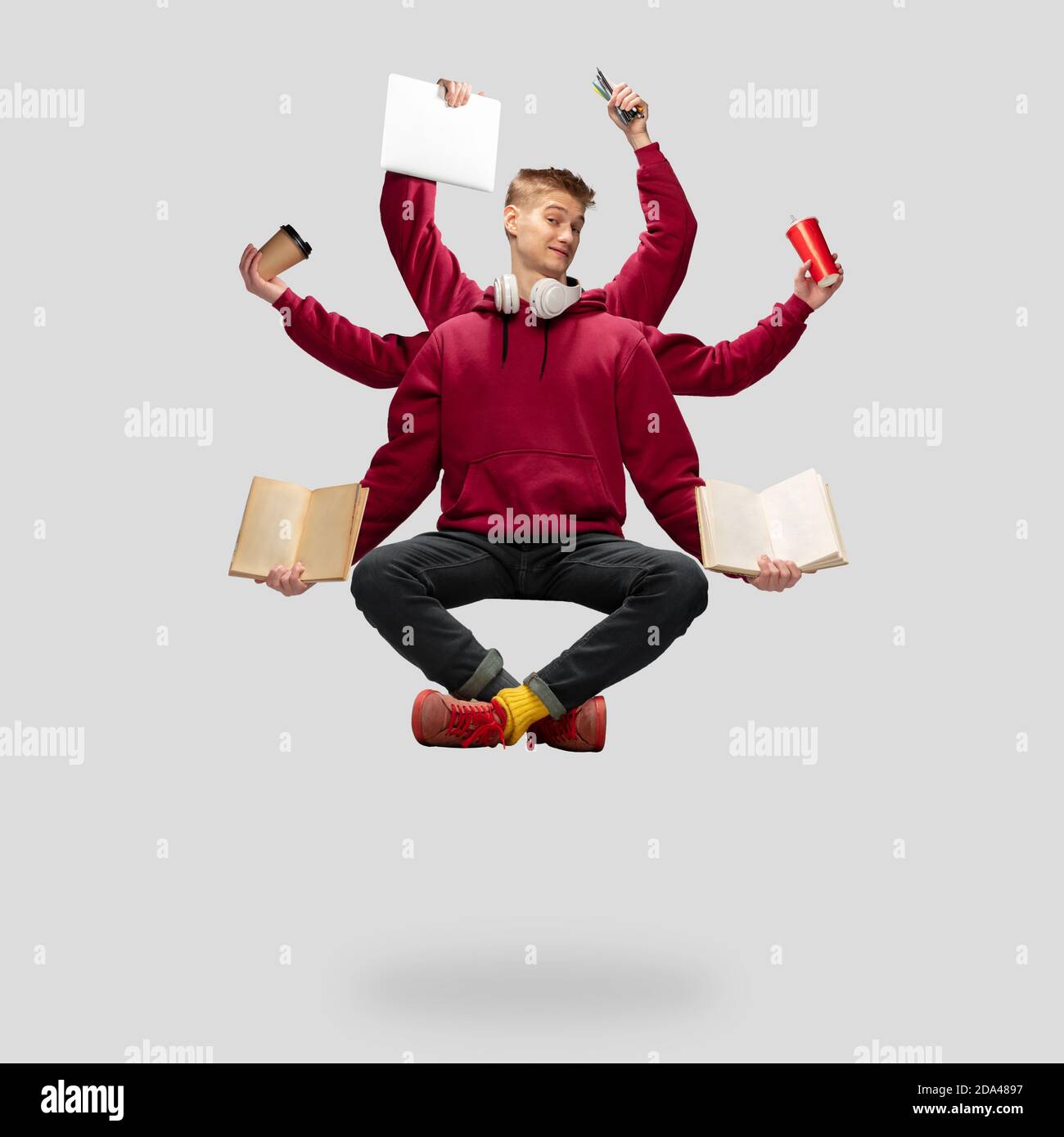 Handsome student, multi-armed man levitating isolated on grey studio ...